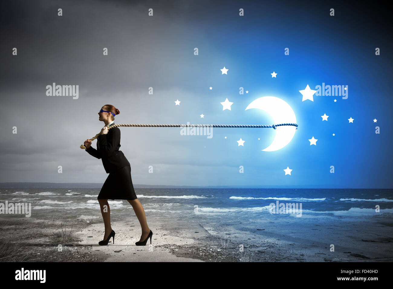 Image of businesswoman pulling moon with rope Stock Photo - Alamy