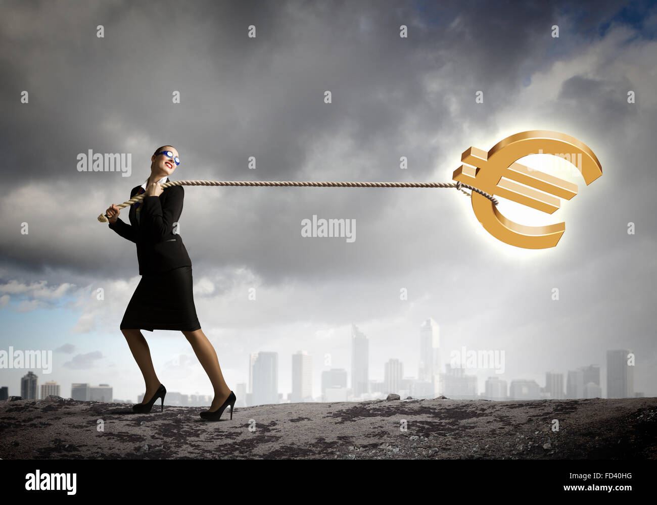 Image of businesswoman pulling euro sign with rope Stock Photo - Alamy