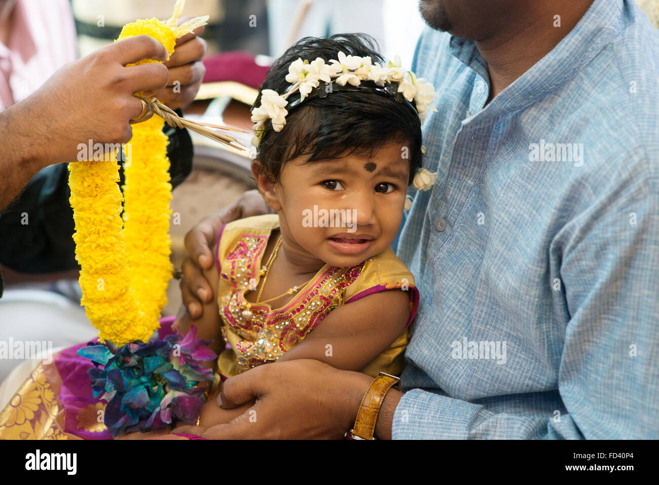Baby girl received flower garland from priest. Traditional Indian ...