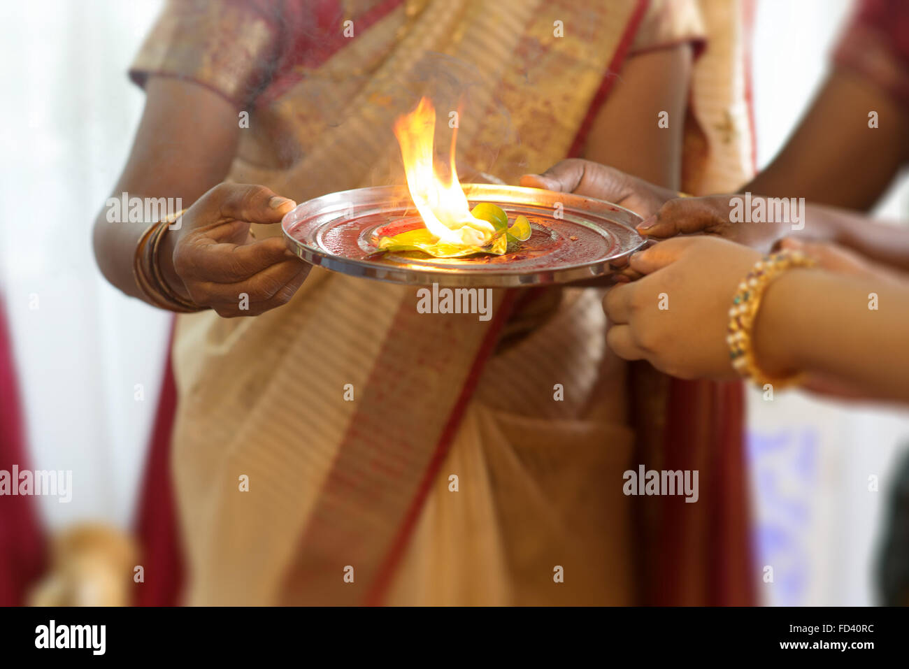 Traditional Indian woman performing special rituals at Hindu ear ...