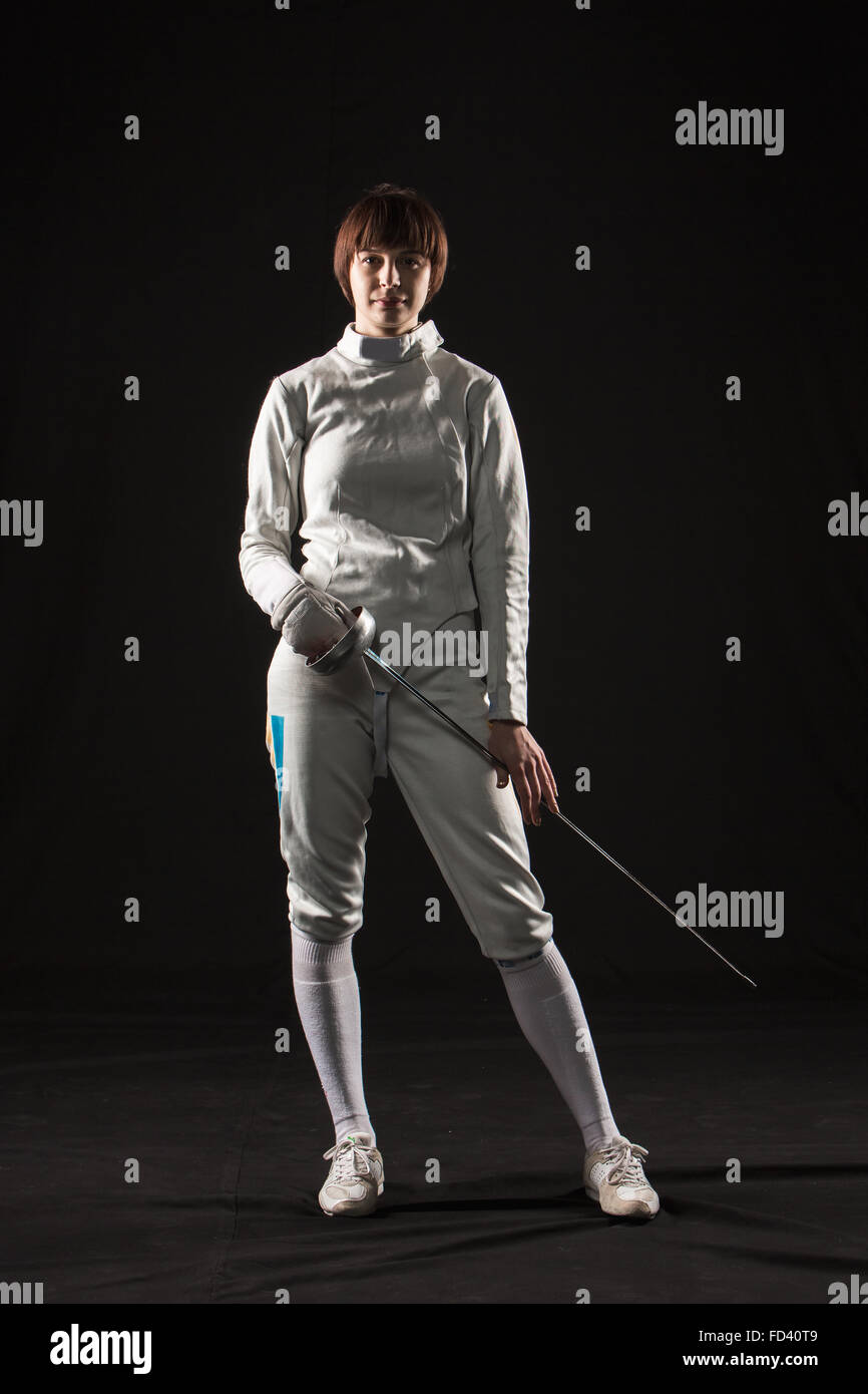 The portrait of woman wearing white fencing costume on black Stock Photo - Alamy