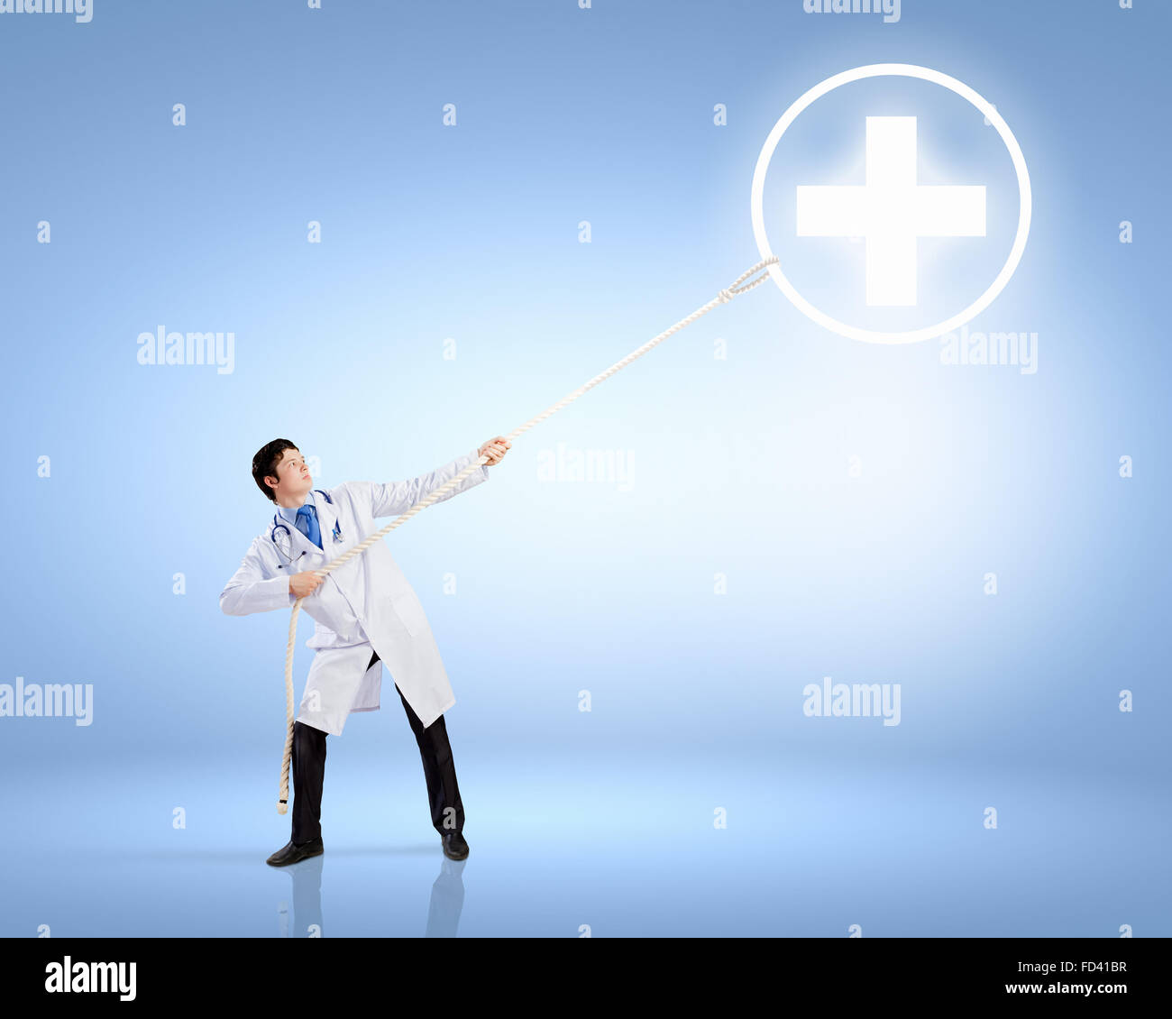 Image of male doctor pulling health sign with rope Stock Photo - Alamy