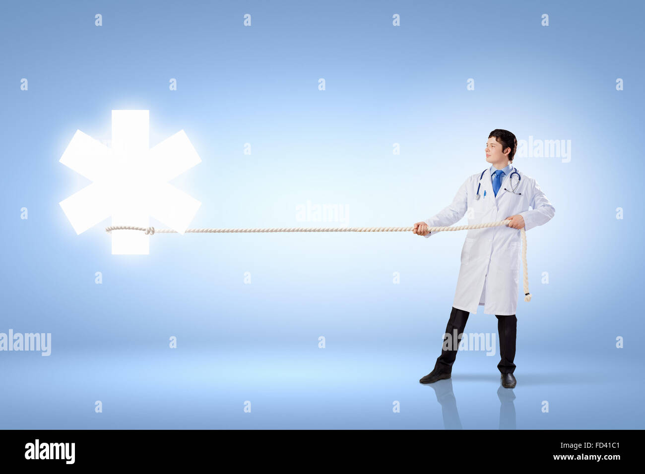 Image of male doctor pulling health sign with rope Stock Photo - Alamy