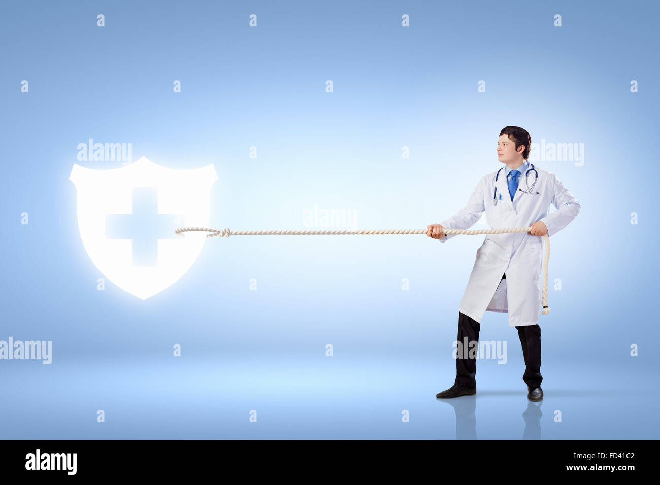 Image of male doctor pulling health sign with rope Stock Photo - Alamy