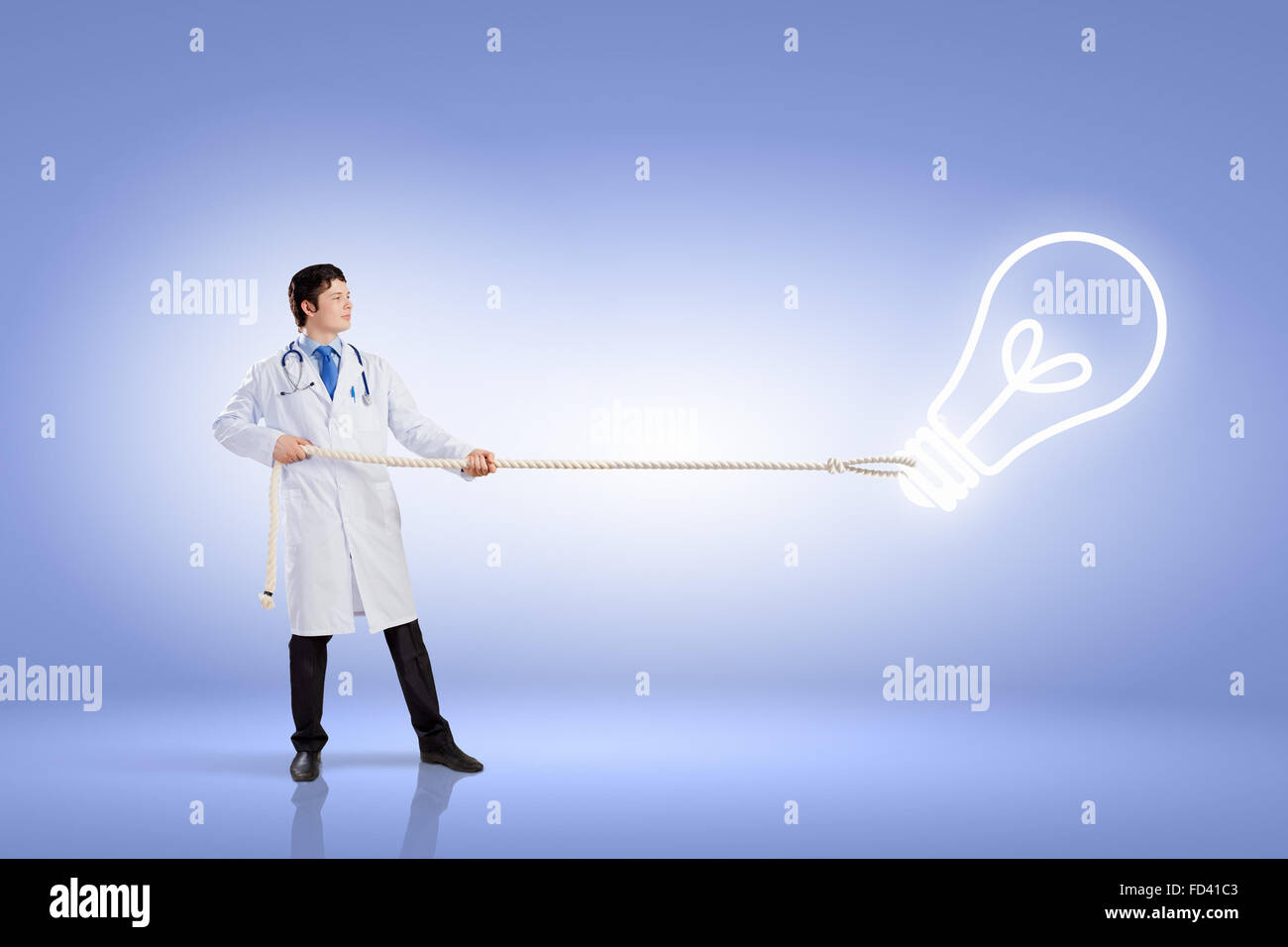Image of male doctor pulling idea sign with rope Stock Photo - Alamy