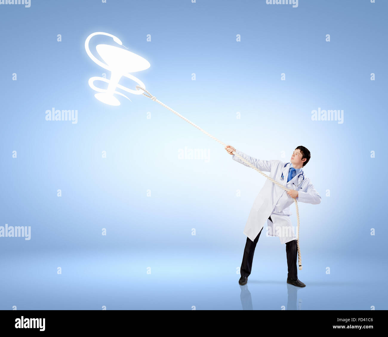 Image of male doctor pulling health sign with rope Stock Photo - Alamy