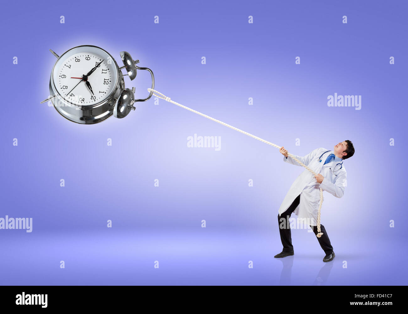 Image of handsome doctor pulling clock with rope Stock Photo - Alamy