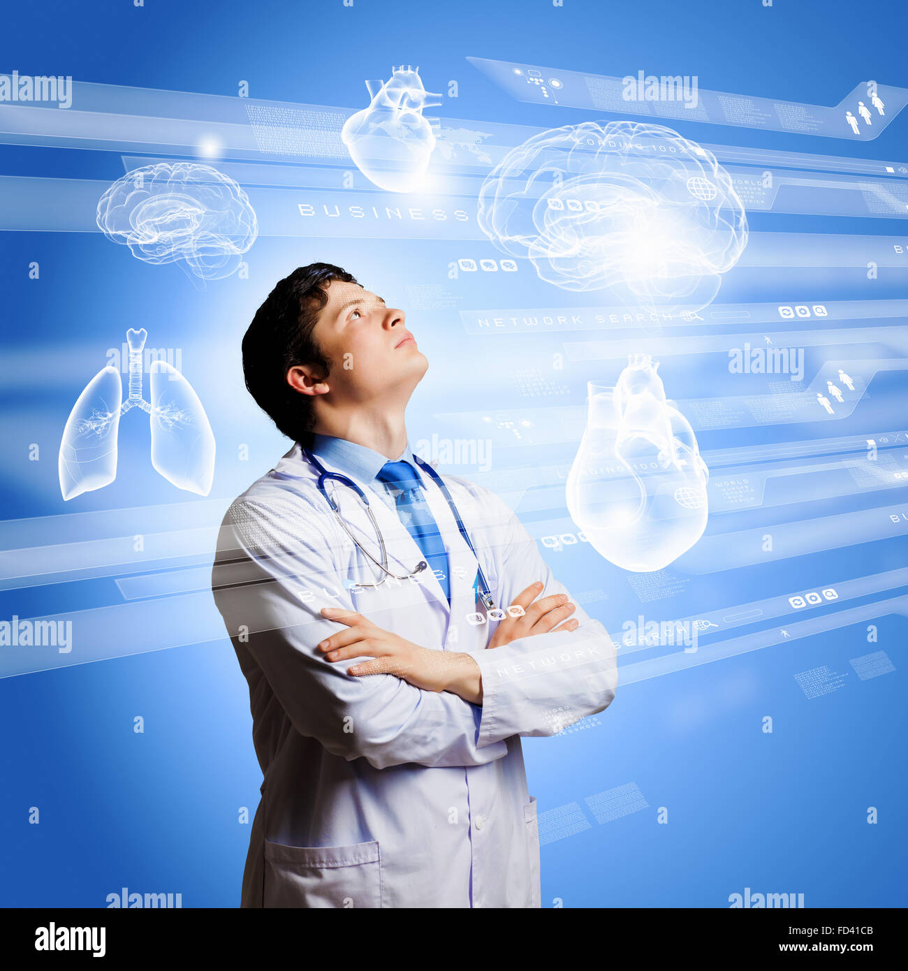 Image of young thoughtful doctor looking at media screen Stock Photo ...
