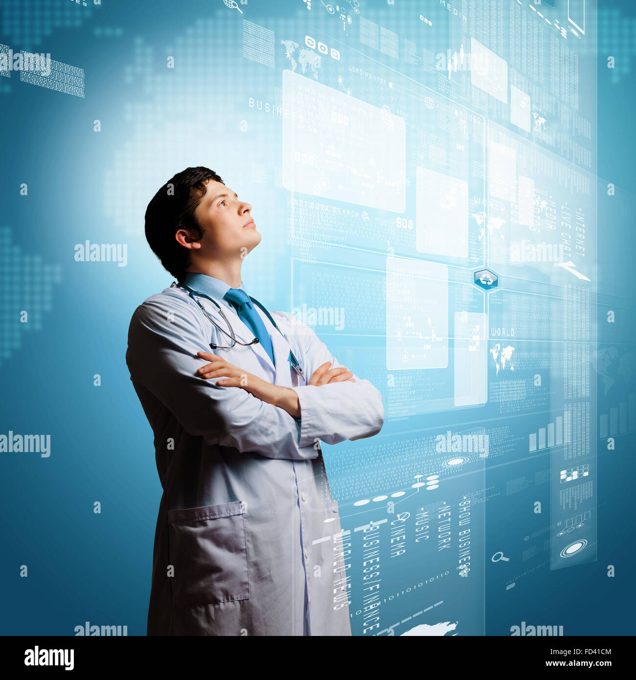 Image of young thoughtful doctor looking at media screen Stock Photo ...