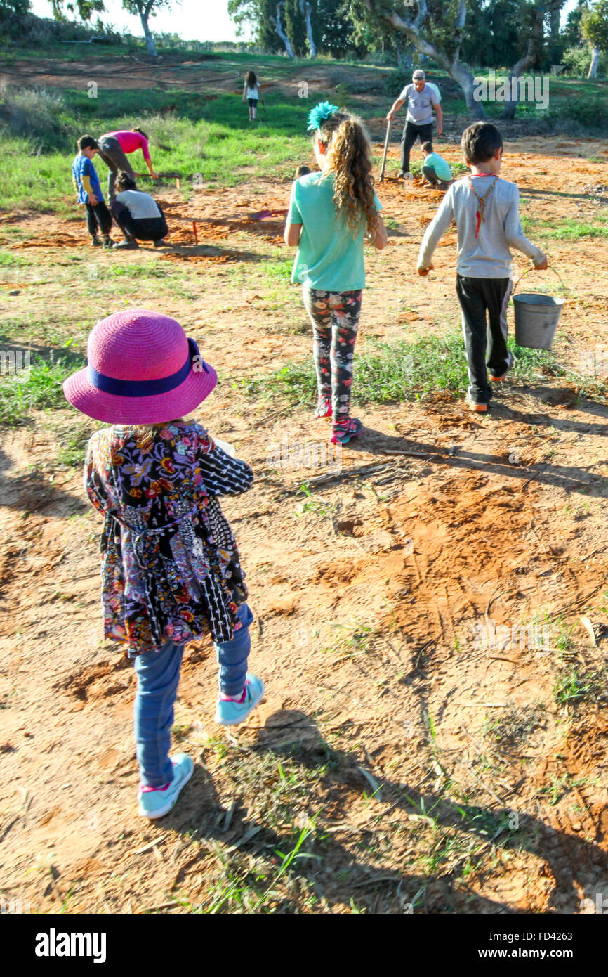 Outdoor activity. Children sowing seeds outside Stock Photo - Alamy