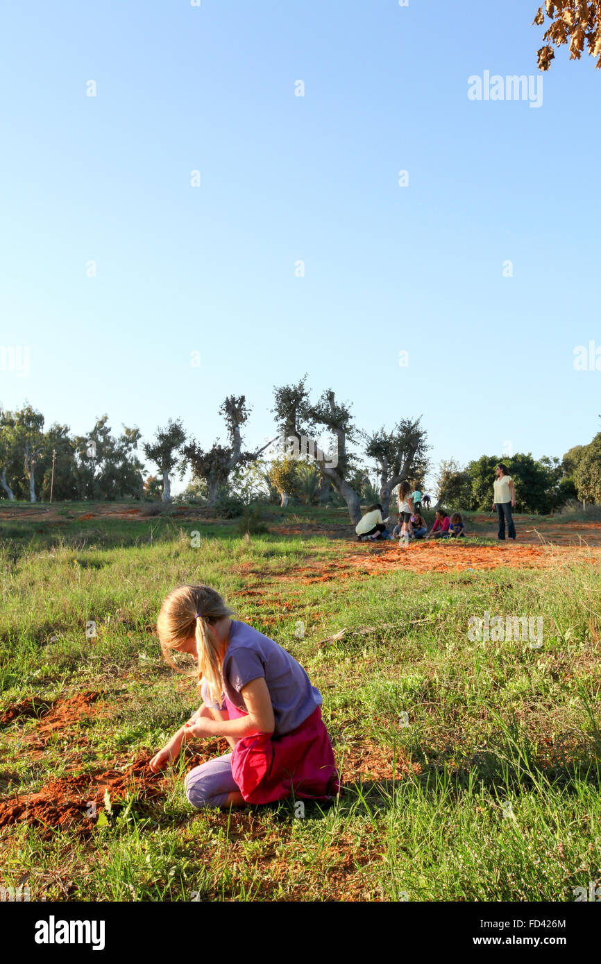 Outdoor activity. Children sowing seeds outside Stock Photo - Alamy