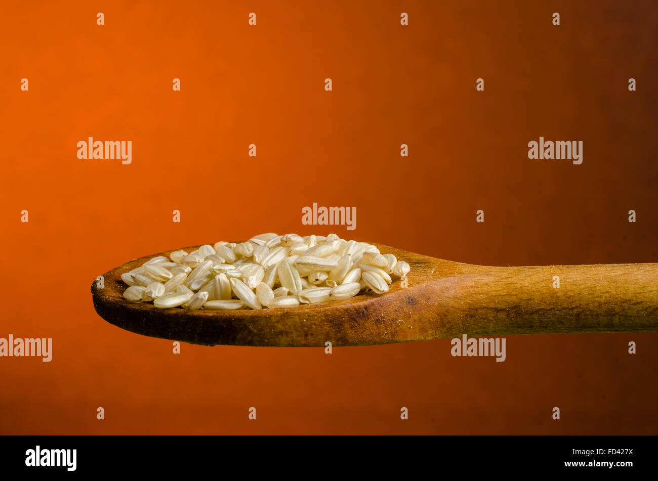 rice in a spoon, close up, color background Stock Photo - Alamy
