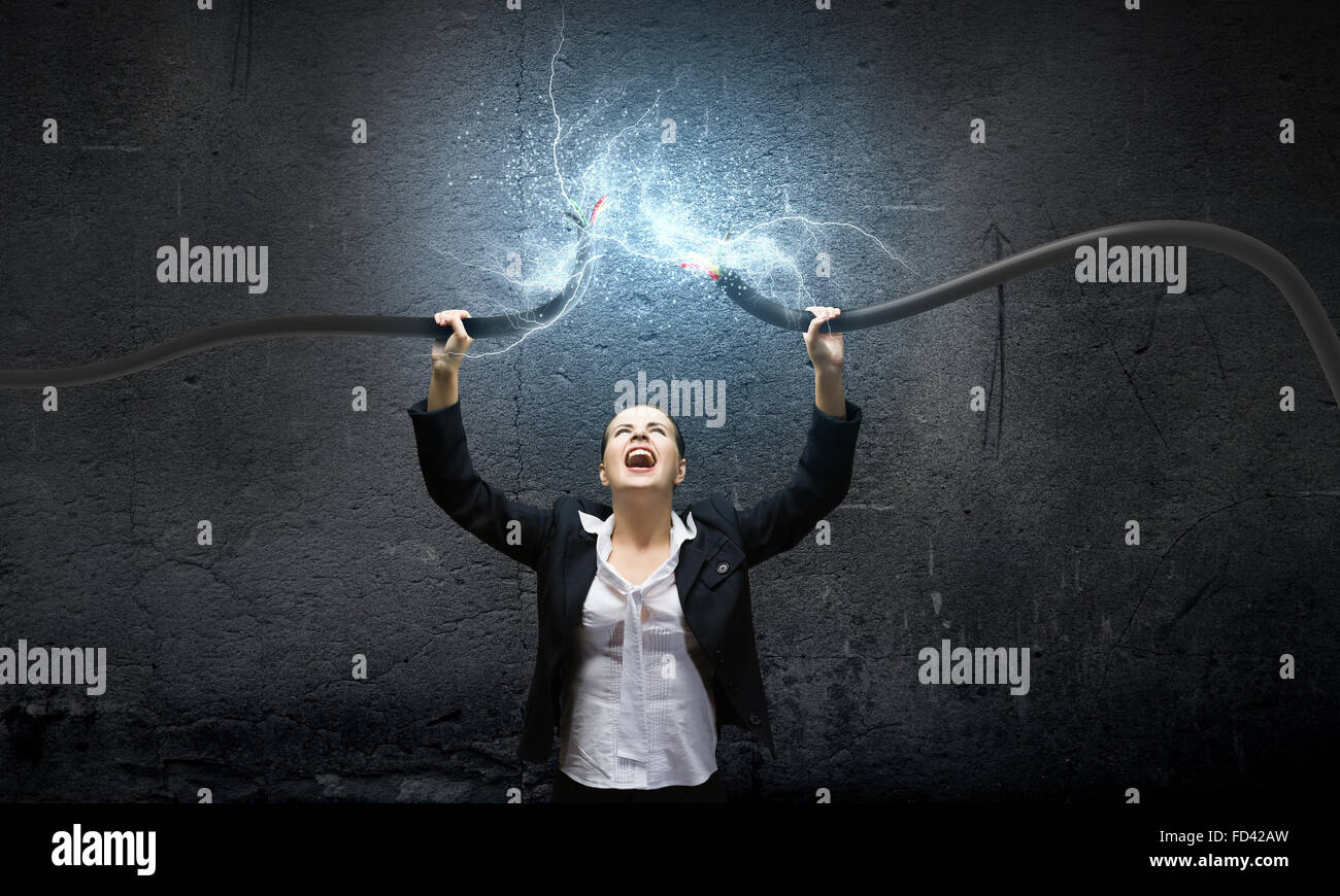 Image of businesswoman holding electrical cable above head Stock Photo ...