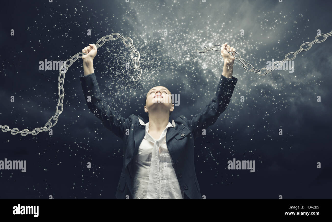 Image of businesswoman in anger breaking metal chain Stock Photo - Alamy