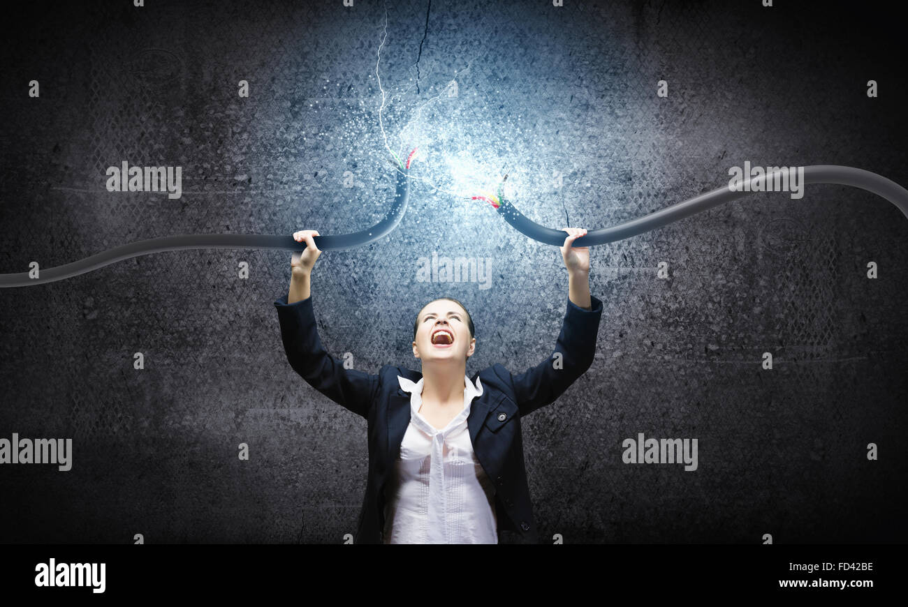 Image of businesswoman holding electrical cable above head Stock Photo ...
