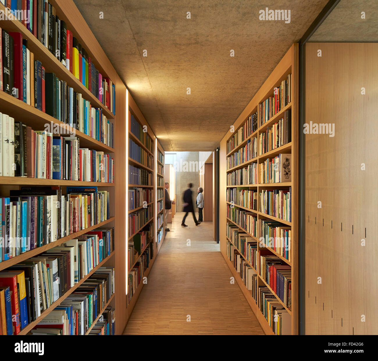 Book aisle corridor leading towards double-height entrance. Britten ...