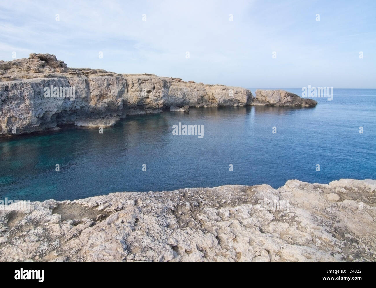Seaside rocky landscape with red limestone cliff in Portinatx, Ibiza ...