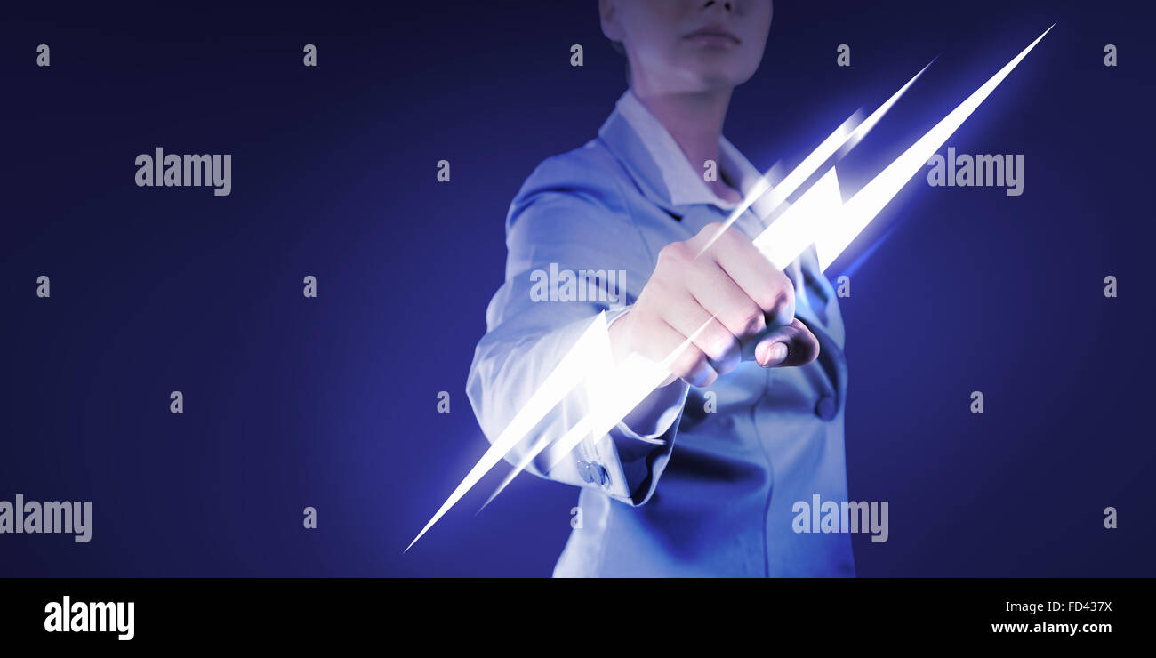 Image of powerful businesswoman holding lightning in fist Stock Photo ...