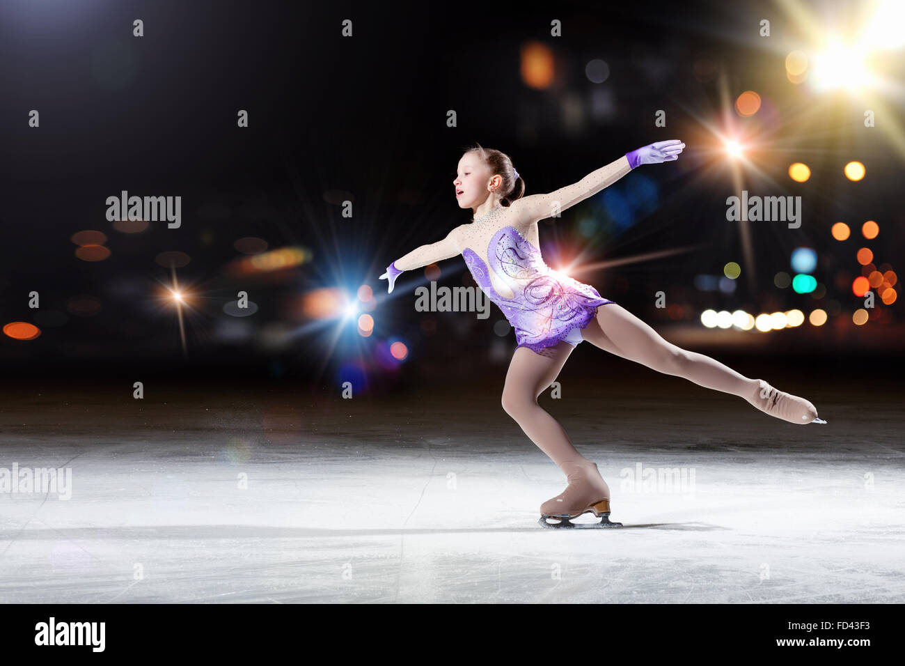 Little girl figure skating at sports arena Stock Photo - Alamy