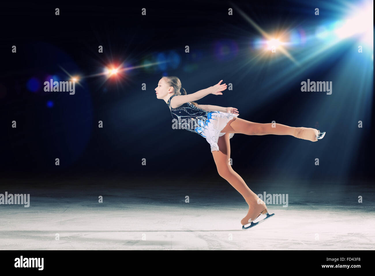 Little girl figure skating at sports arena Stock Photo - Alamy