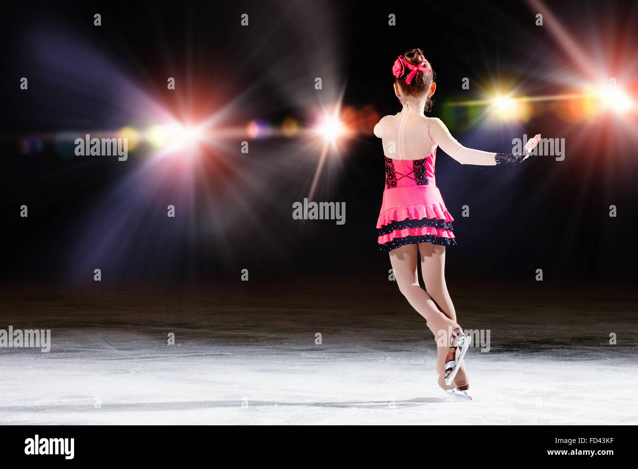 Little girl figure skating at sports arena Stock Photo - Alamy