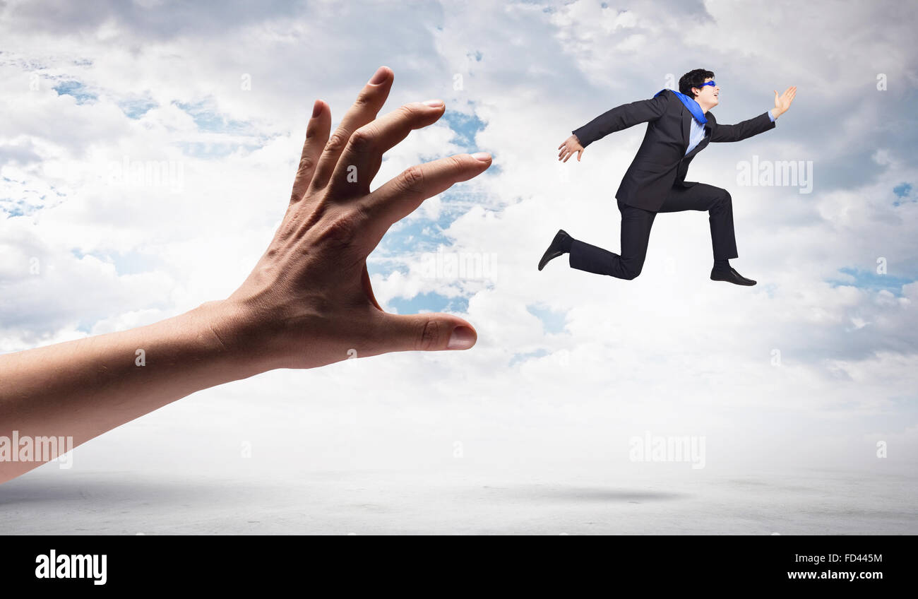 funny image of businessman trying to run away from hand Stock Photo - Alamy
