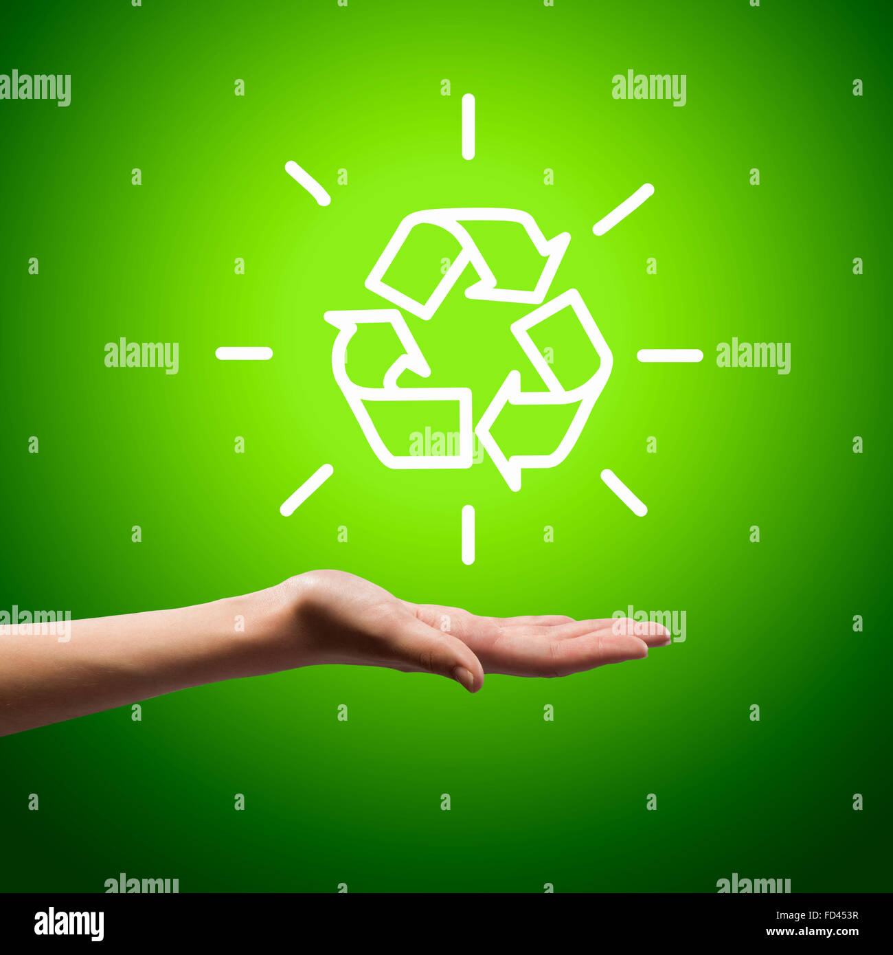 Recycling symbol in human hand against green background Stock Photo - Alamy