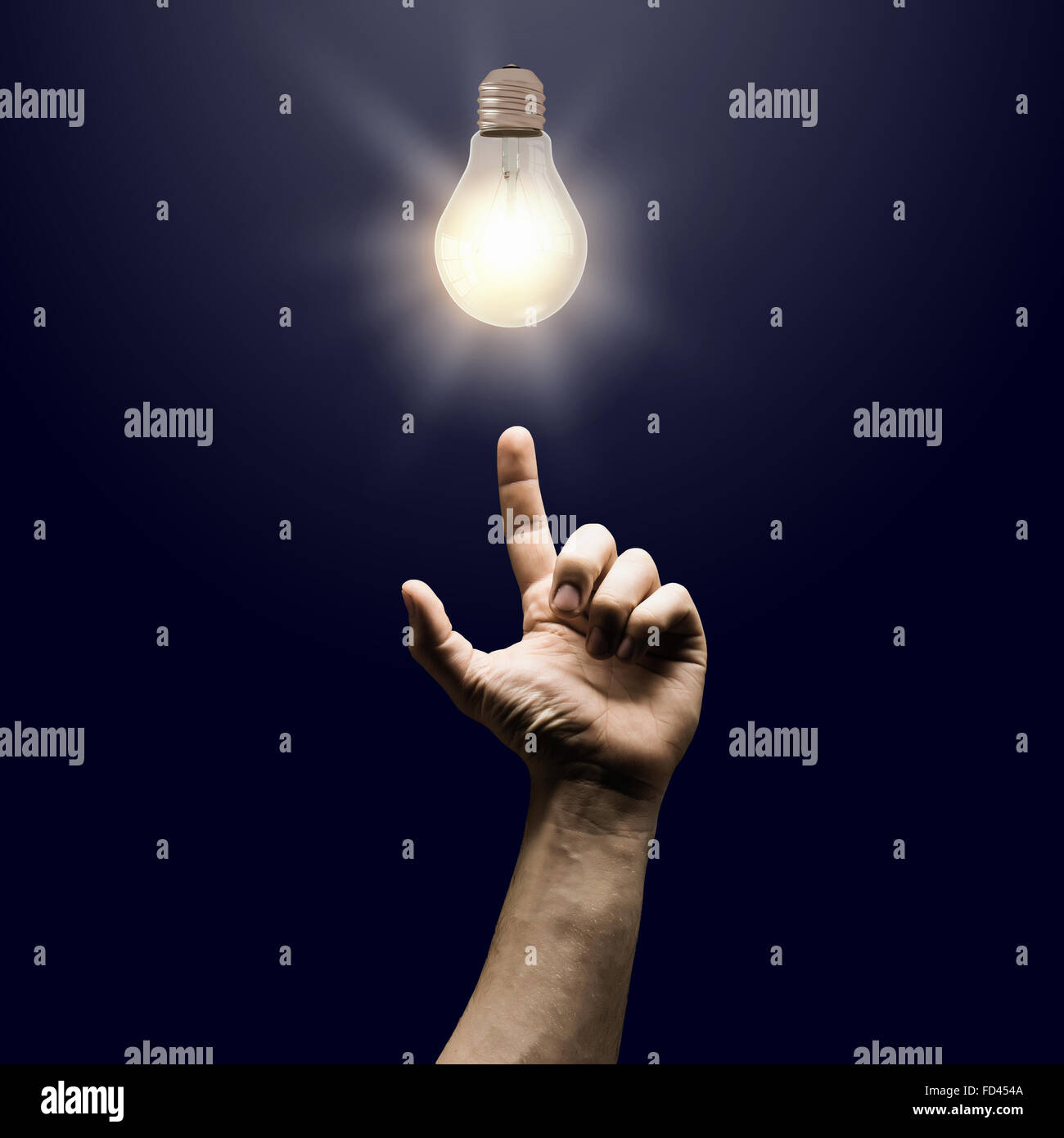 Human hand pointing with finger at electrical bulb Stock Photo - Alamy