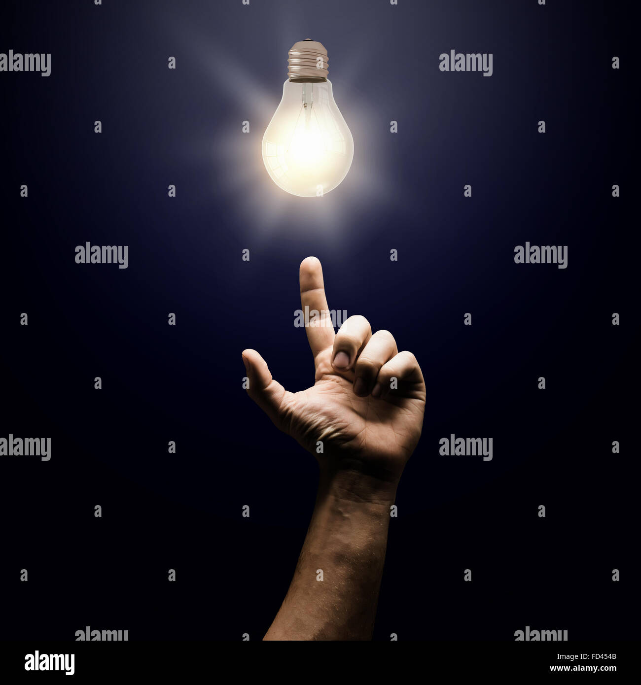 Human hand pointing with finger at electrical bulb Stock Photo - Alamy