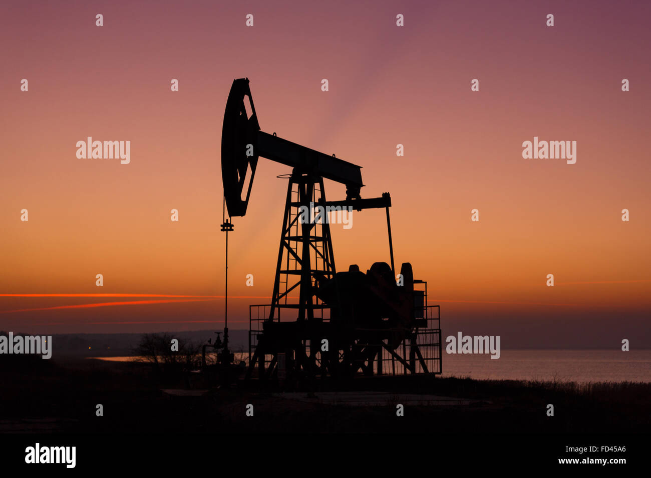 Oil derricks on the background of sunset Stock Photo - Alamy