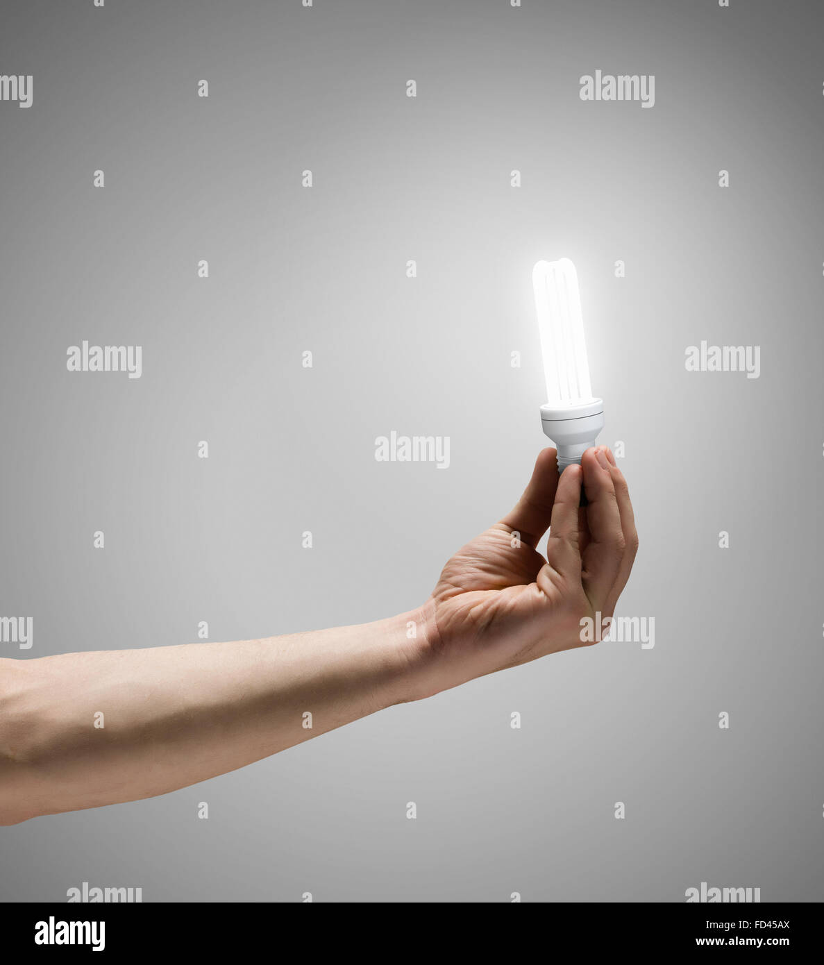 Close up image of human hand holding electrical bulb Stock Photo - Alamy