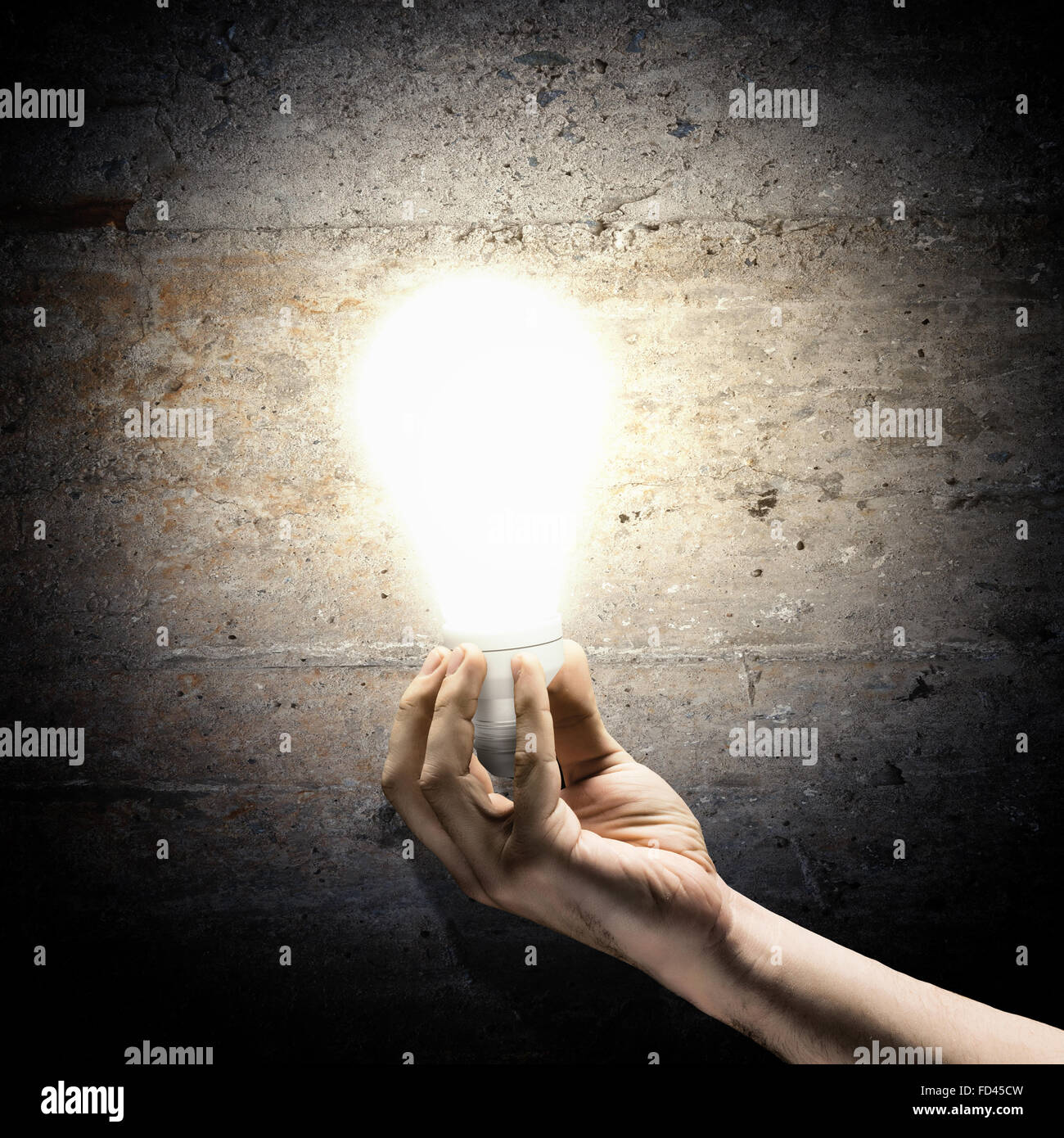 Close up image of human hand holding electrical bulb in darkness Stock ...