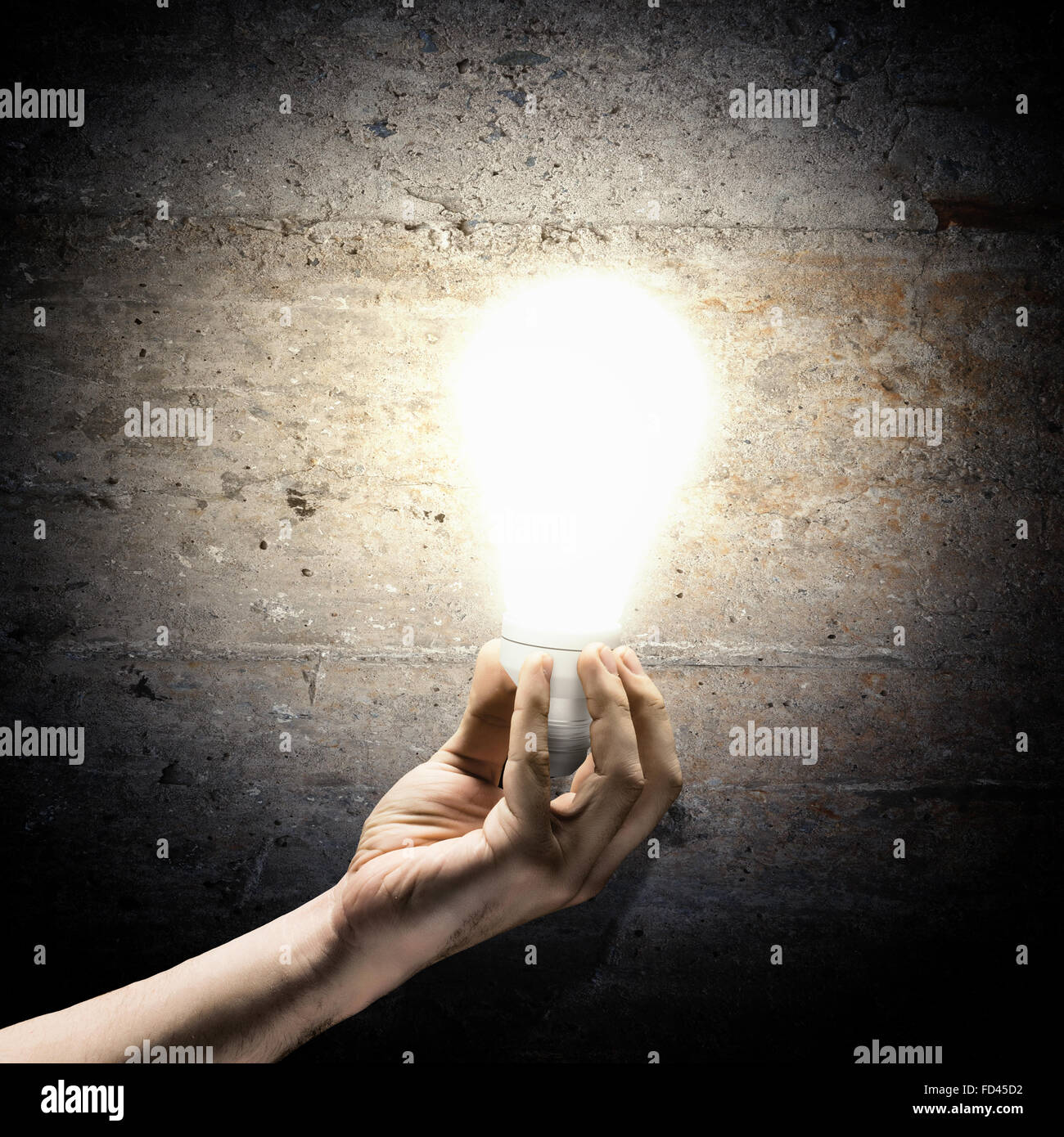 Close up image of human hand holding electrical bulb in darkness Stock ...