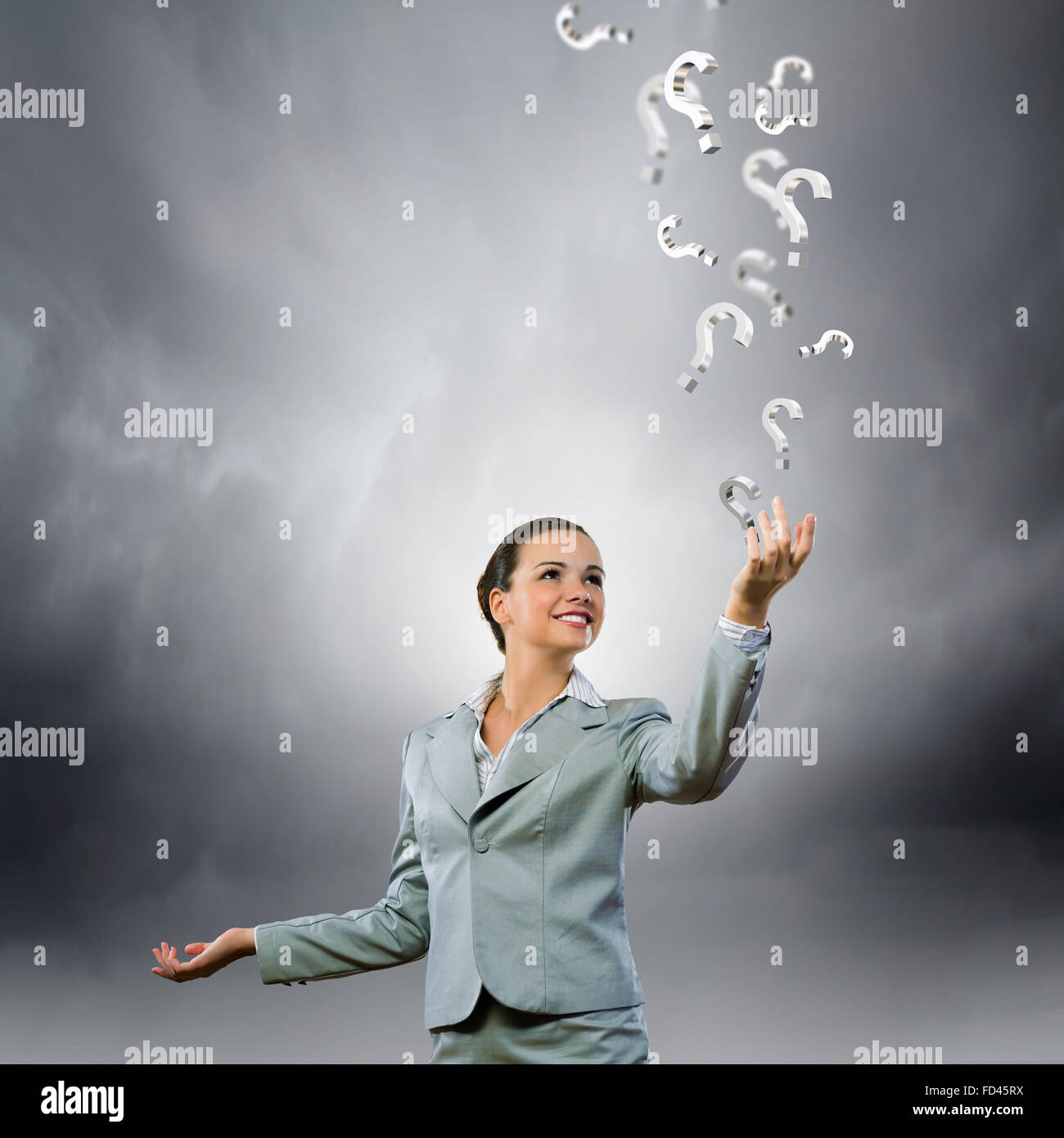 Image of young attractive businesswoman holding question marks in hand ...