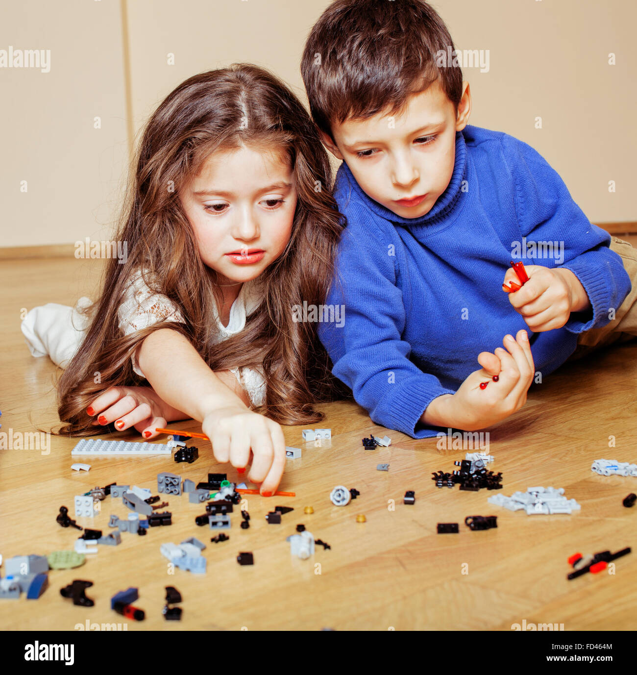 funny cute children playing lego at home, boys and girl smiling, first ...