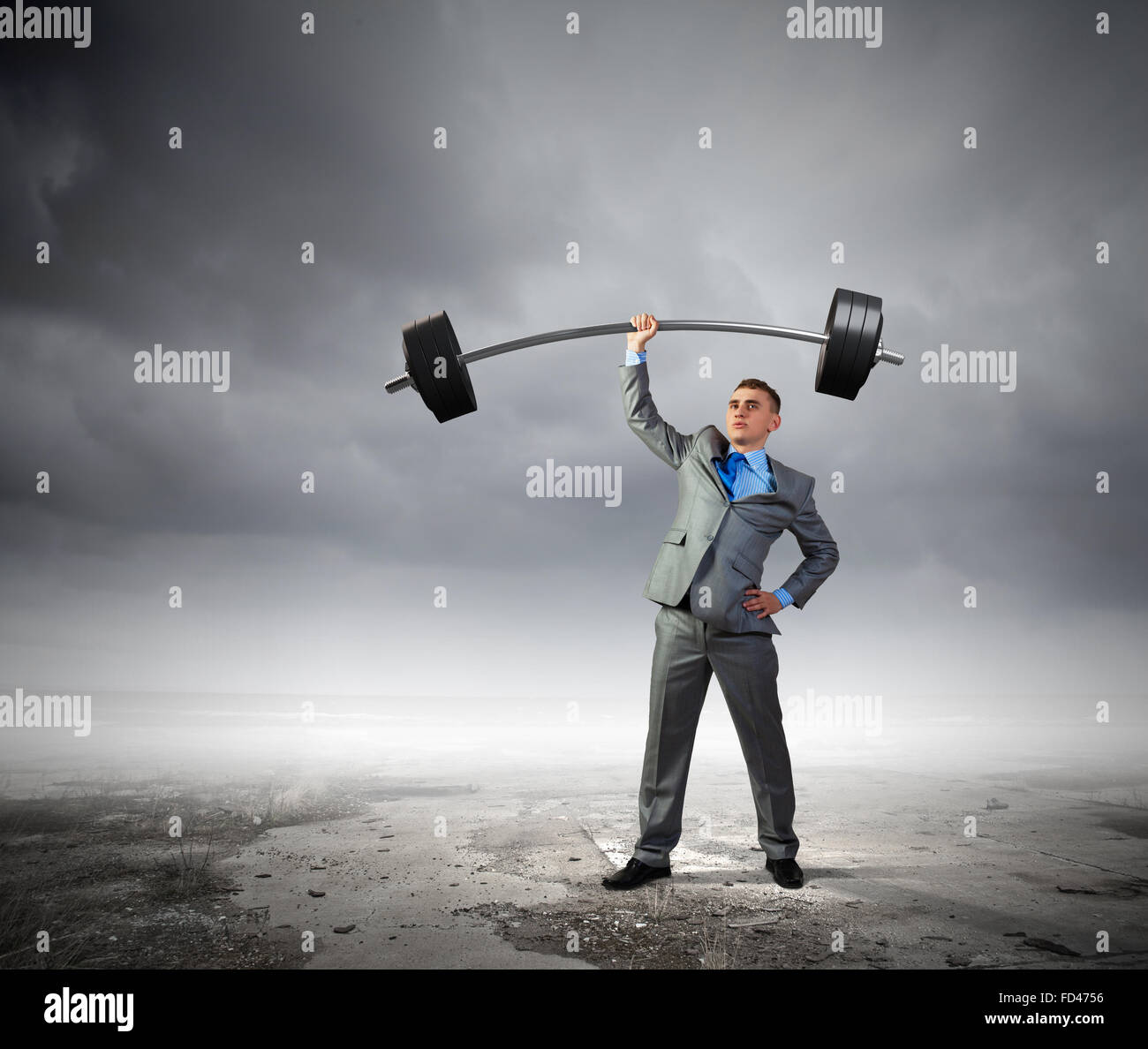Image of strong businessman lifting barbell above head with one hand ...