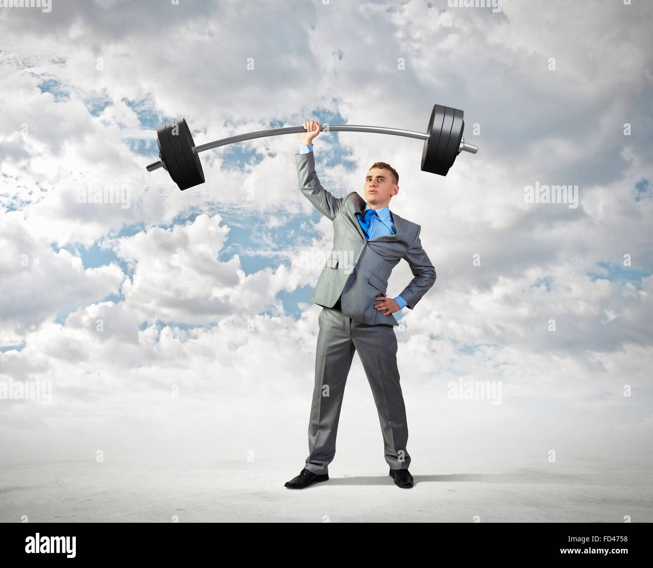 Image of strong businessman lifting barbell above head with one hand ...