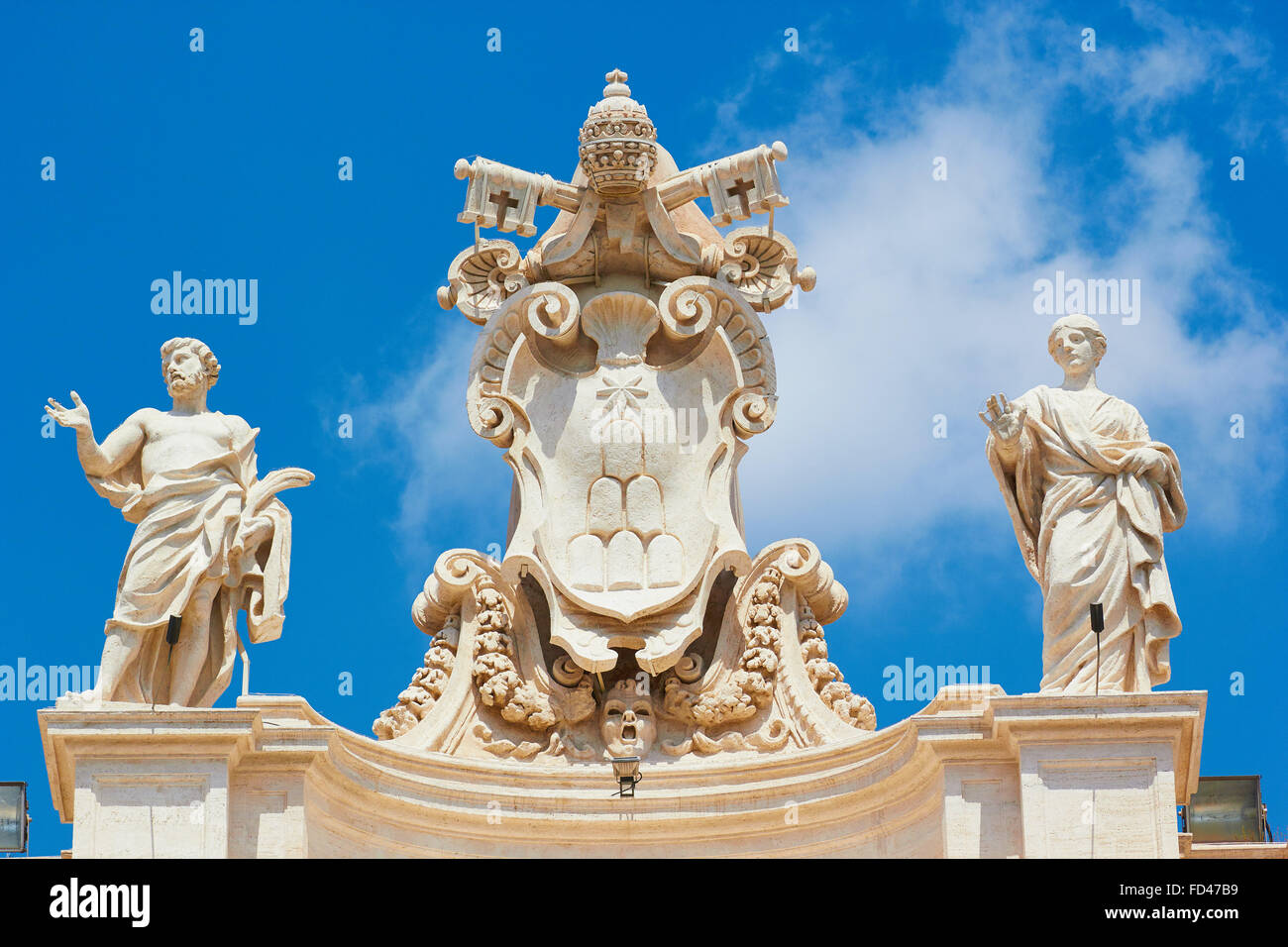 Statues of saints flanking a papal crest above Piazza San Pietro Rome ...