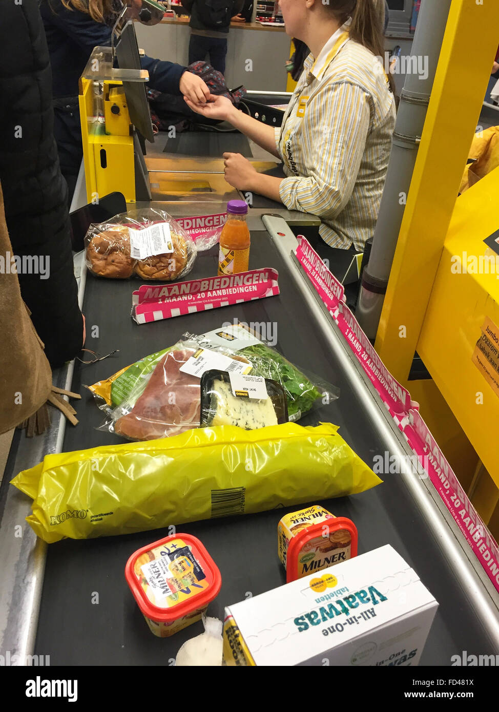 Cashier working at the cash register in a supermarket Stock Photo - Alamy
