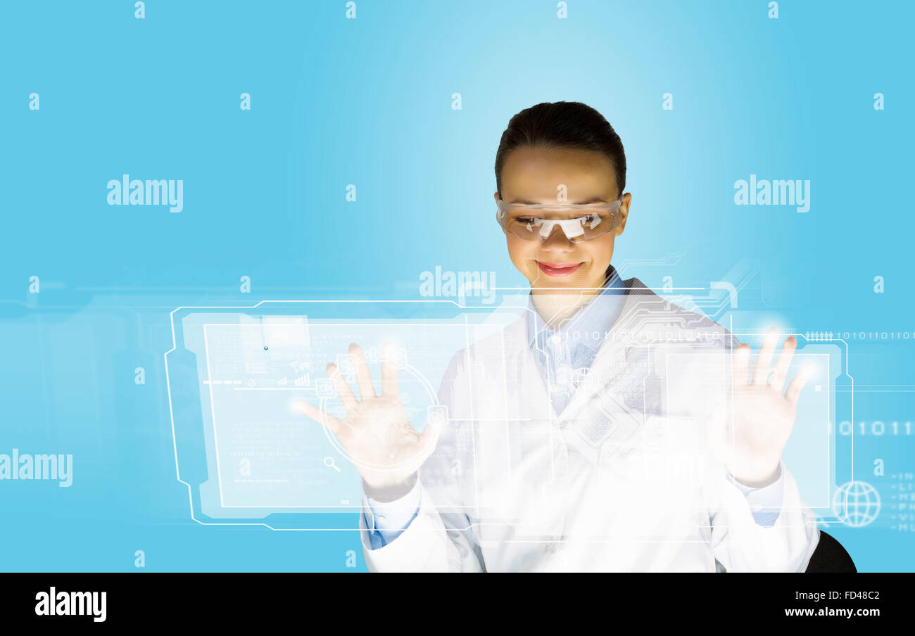 Image of young woman scientist touching icon of media screen Stock ...