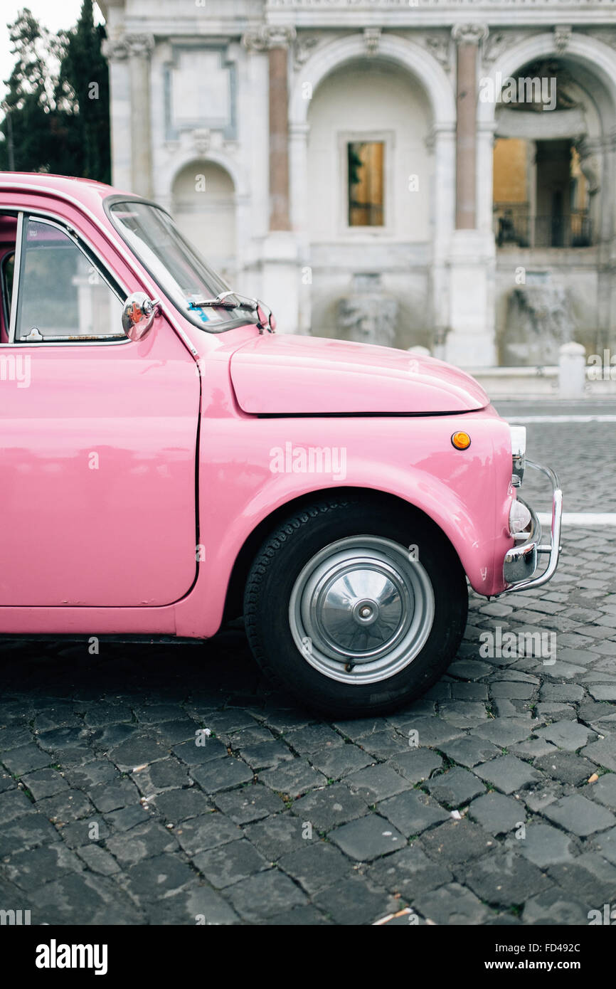 A pink vintage Fiat 500 car in Rome, Italy, in front of the Fontanone ...