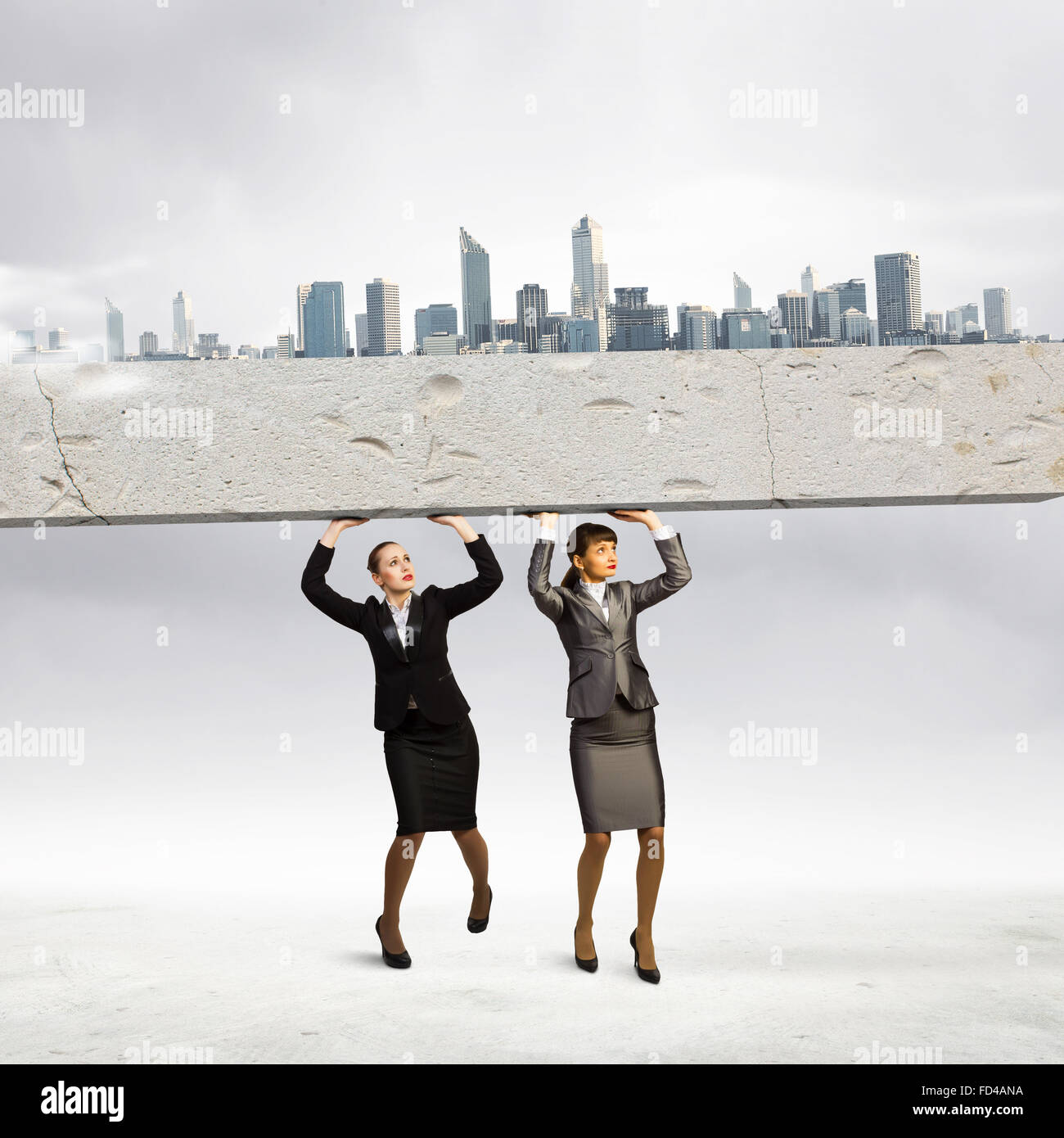 Image of two businesswomen holding stone above head. Partnership and ...