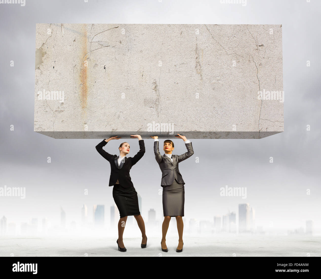 Image of two businesswomen holding stone above head. Partnership and ...