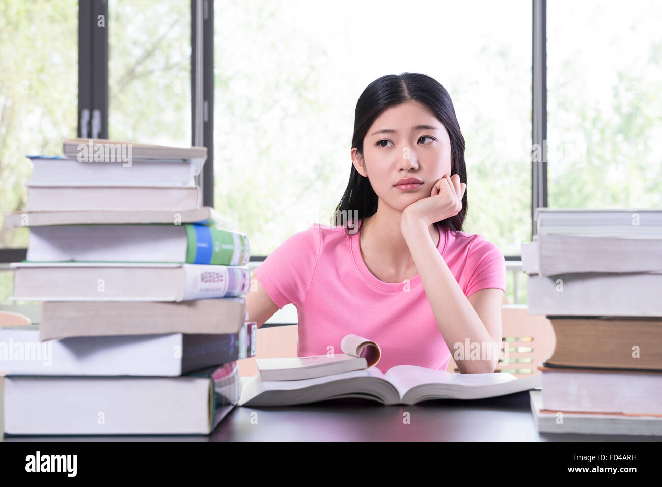 College student studying in library Stock Photo - Alamy