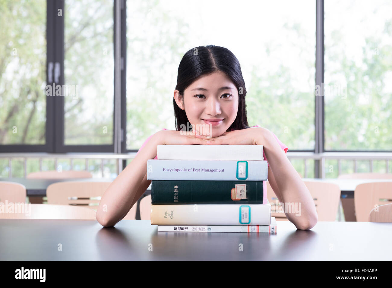 Portrait of college student in library Stock Photo - Alamy