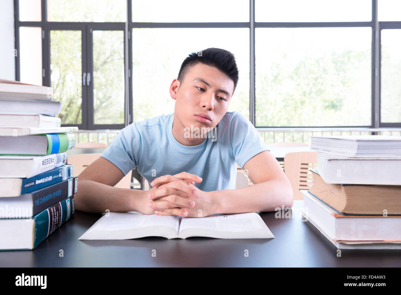 College student studying in library Stock Photo - Alamy