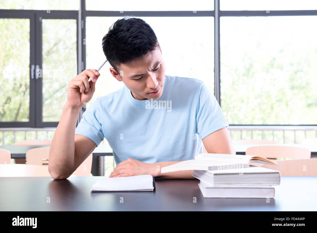 College student studying in library Stock Photo - Alamy