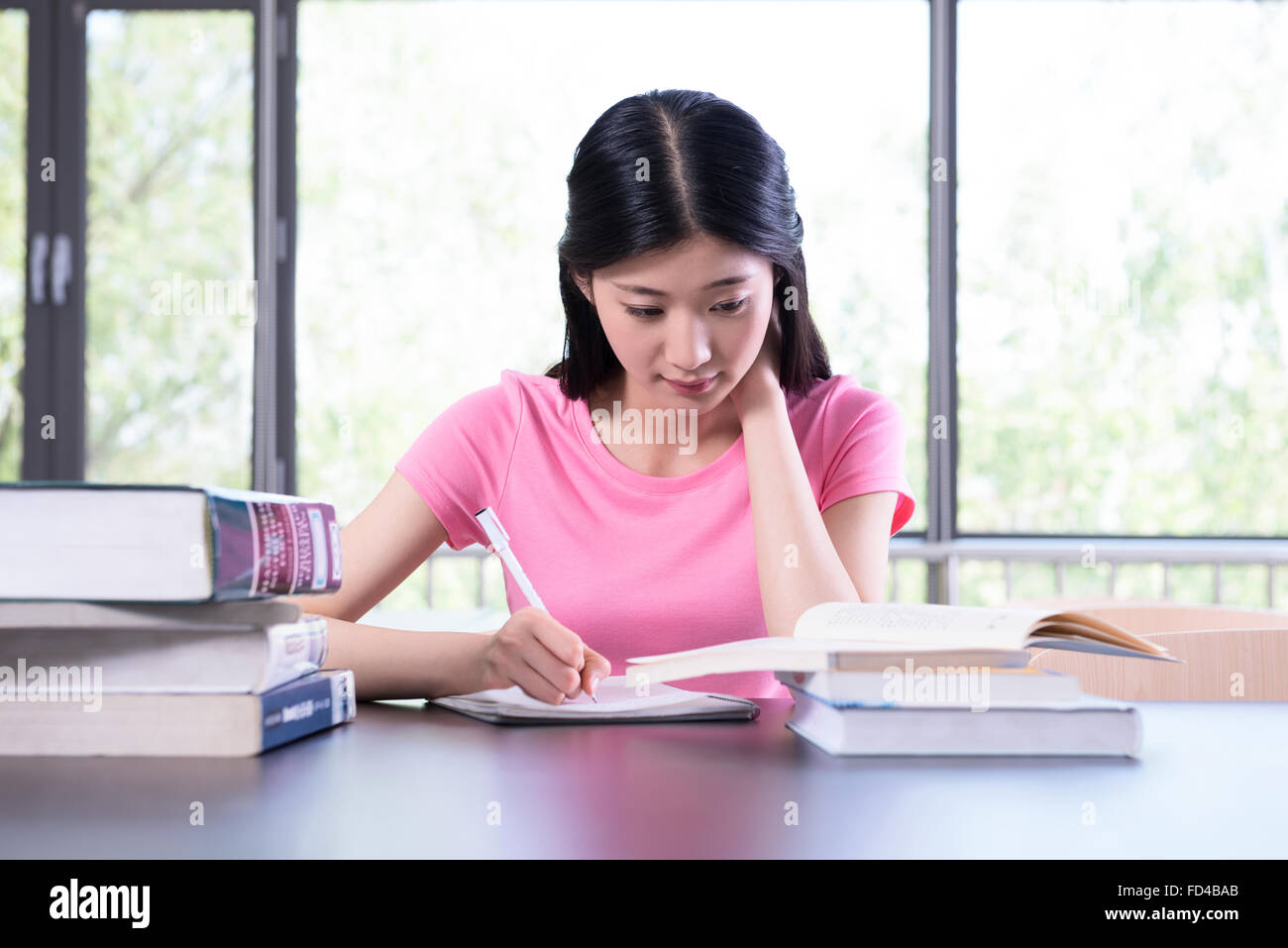 College student studying in library Stock Photo - Alamy