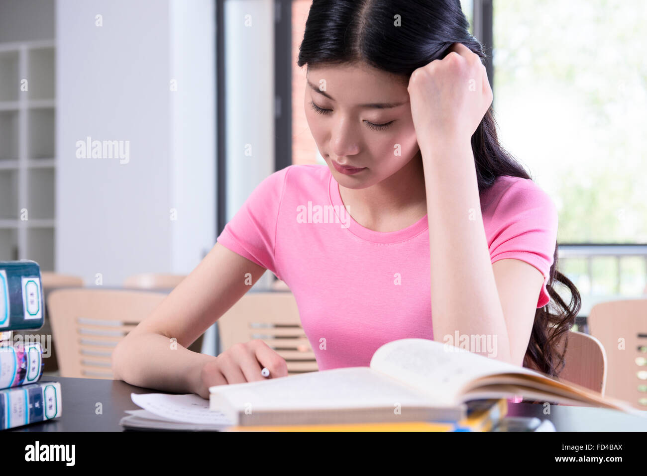 College student falling asleep in library Stock Photo - Alamy