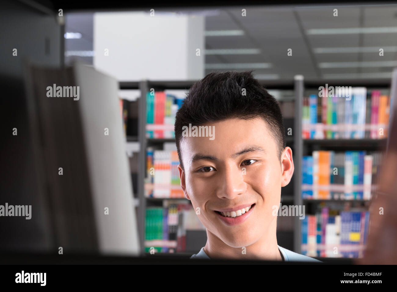 Portrait of college student in library Stock Photo - Alamy